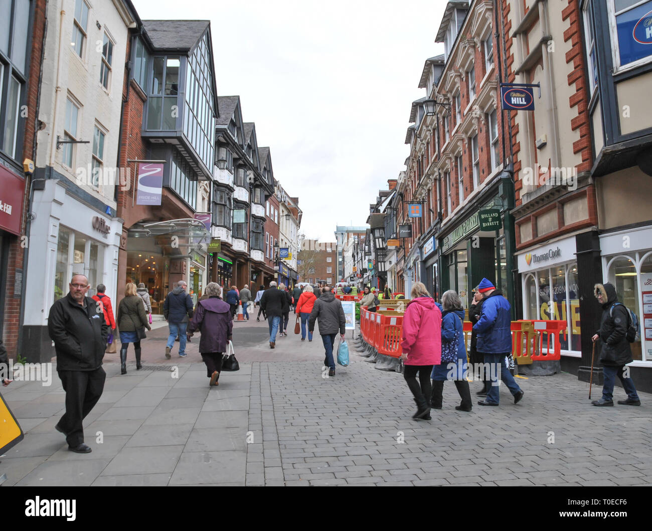 A busy street in an English town centre showing people shopping and ...