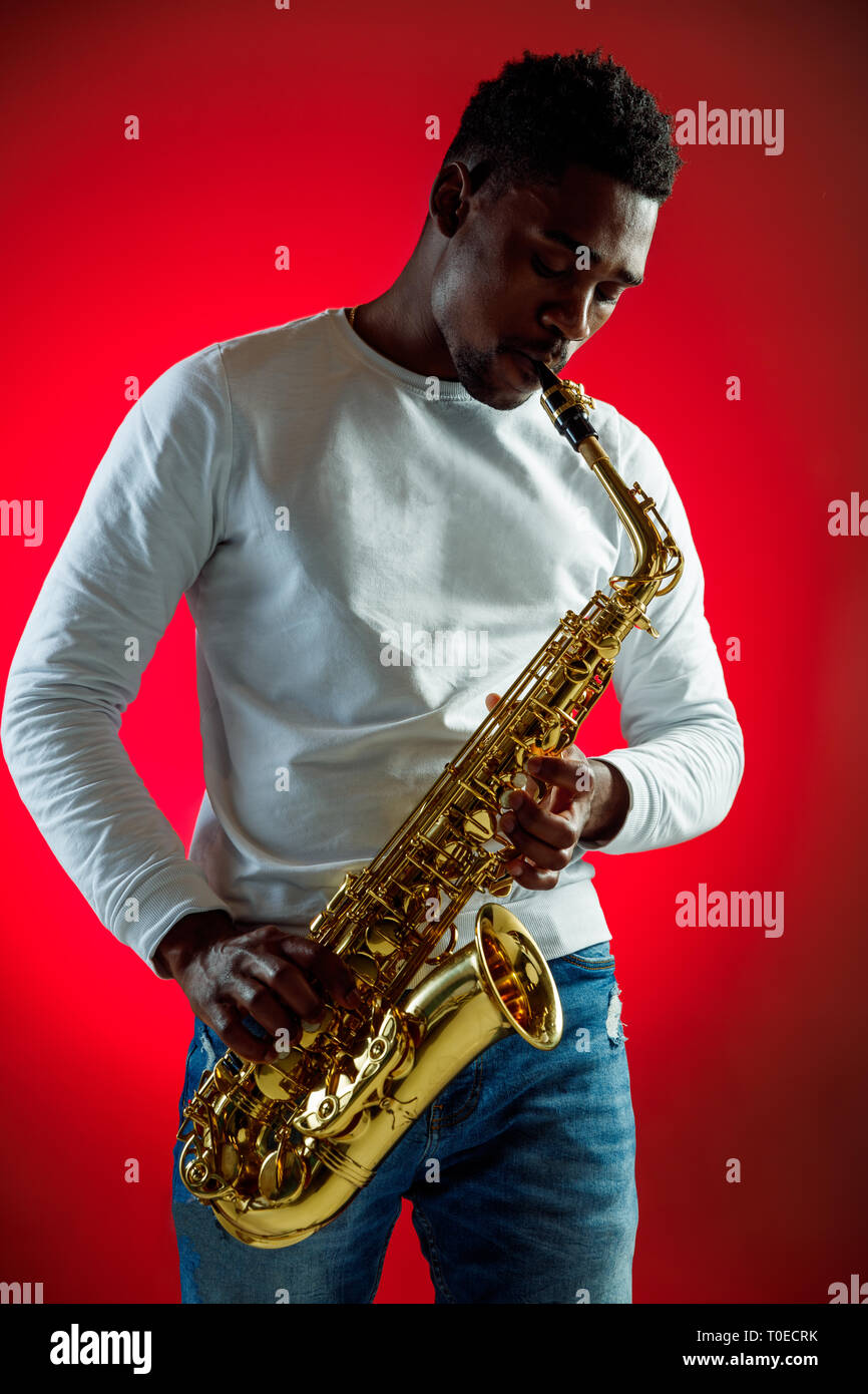 African American handsome jazz musician playing the saxophone in the ...