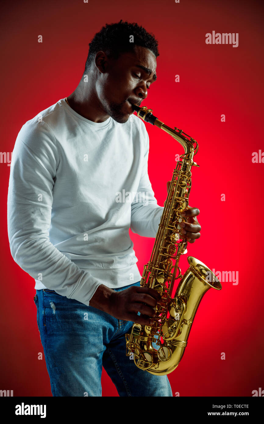 African American handsome jazz musician playing the saxophone in the ...
