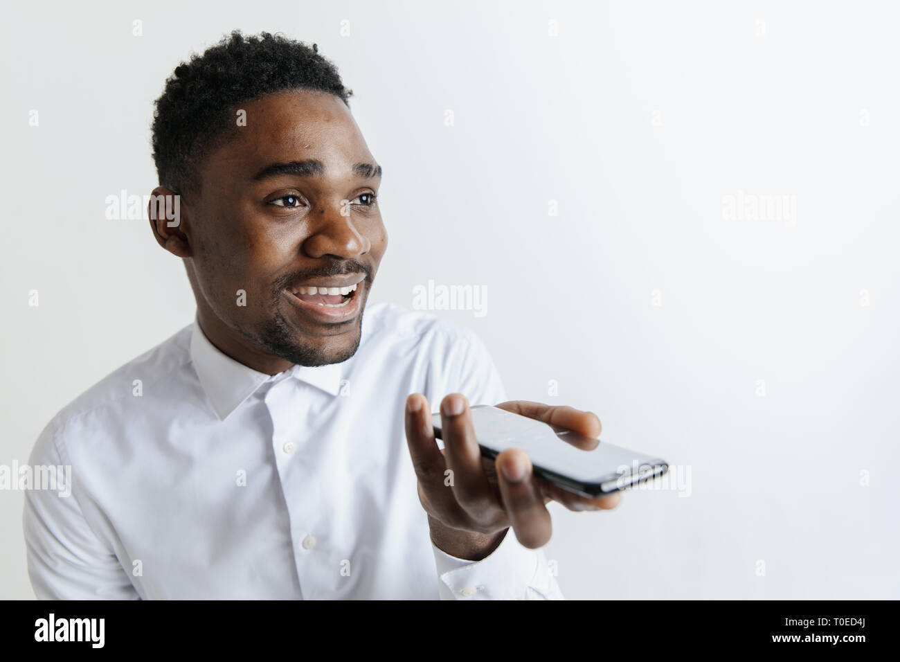 Indoor portrait of attractive young black african man isolated on gray ...