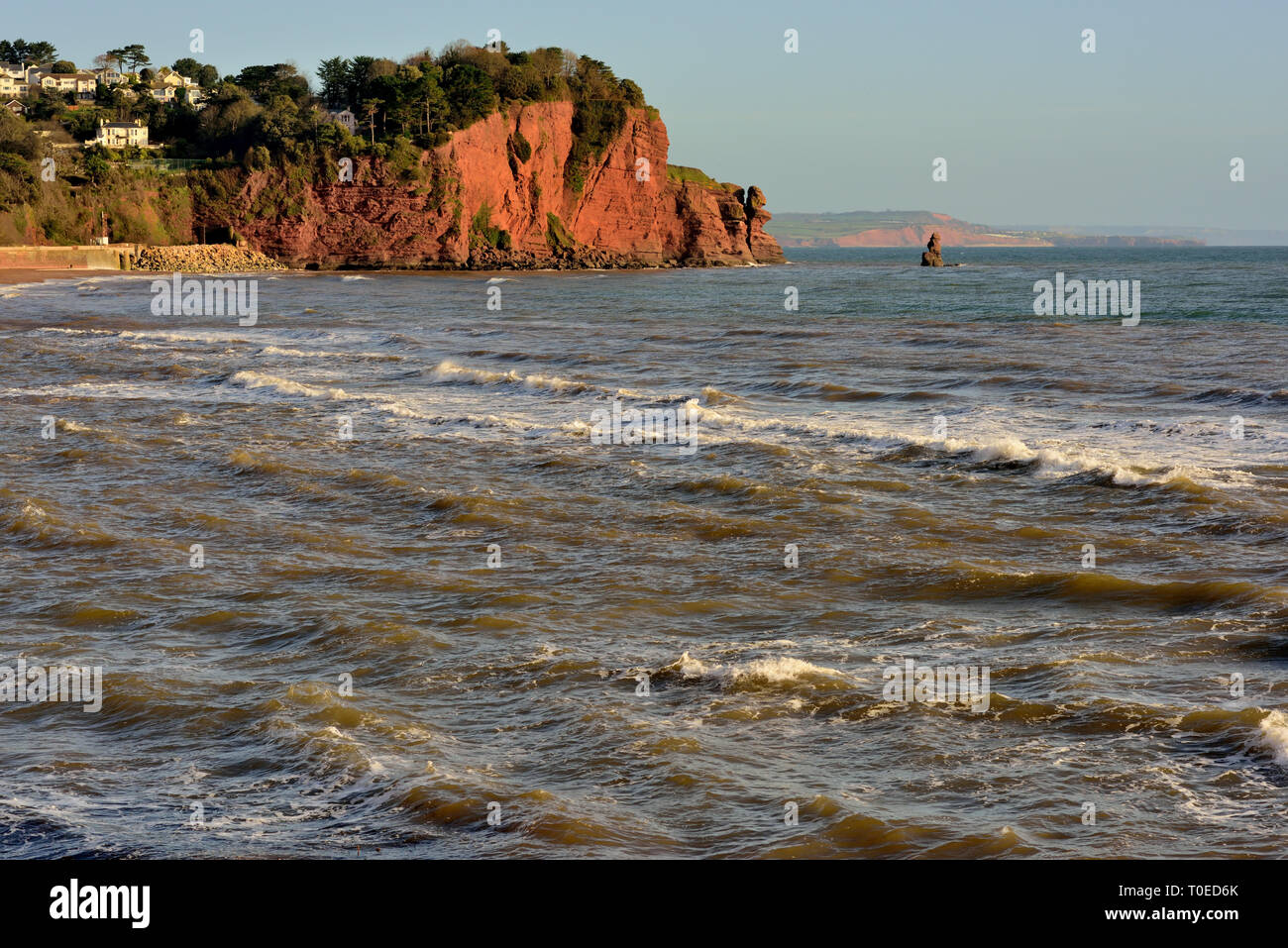 Incoming tide at Holcombe beach and the red sandstone cliffs of Hole ...