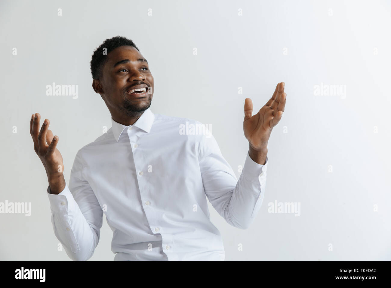Portrait of excited young African American male screaming in shock and ...