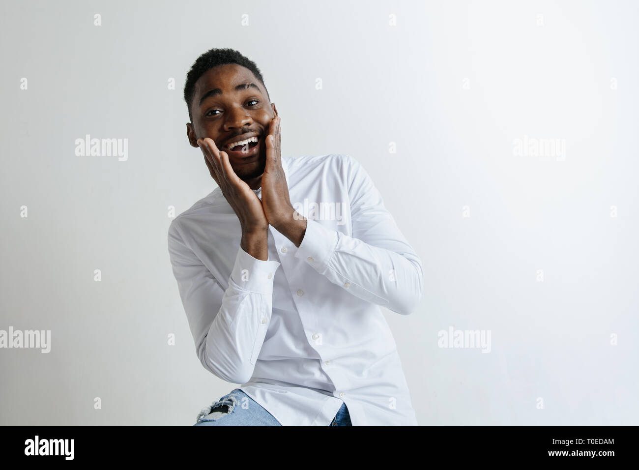 Portrait of excited young African American male screaming in shock and ...