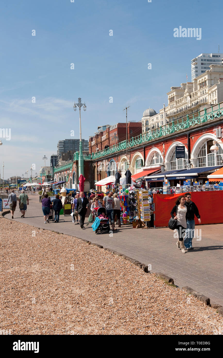 People walk along the promenade in brighton hi-res stock photography ...