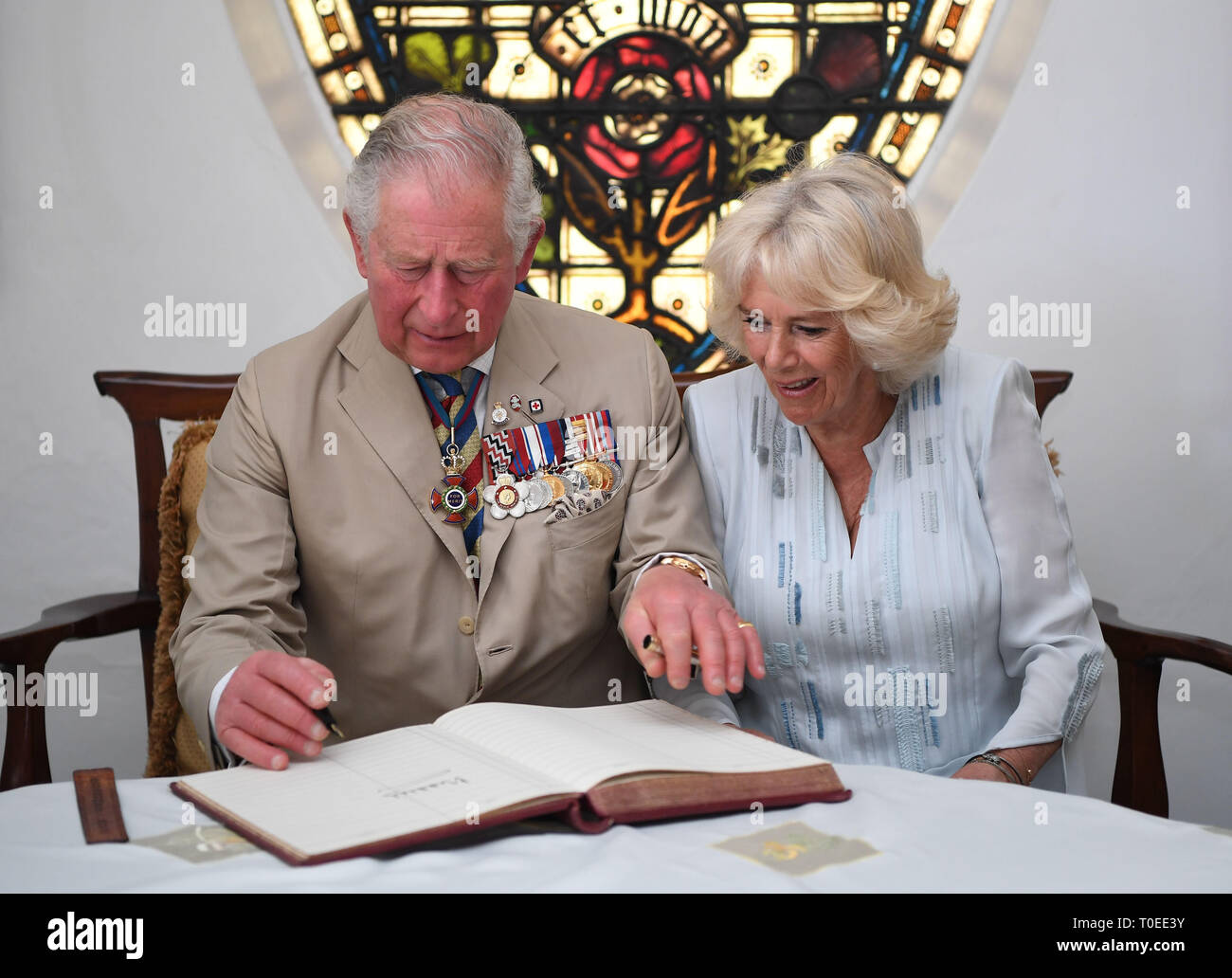 The Prince of Wales and the Duchess of Cornwall sign the visitor's book ...