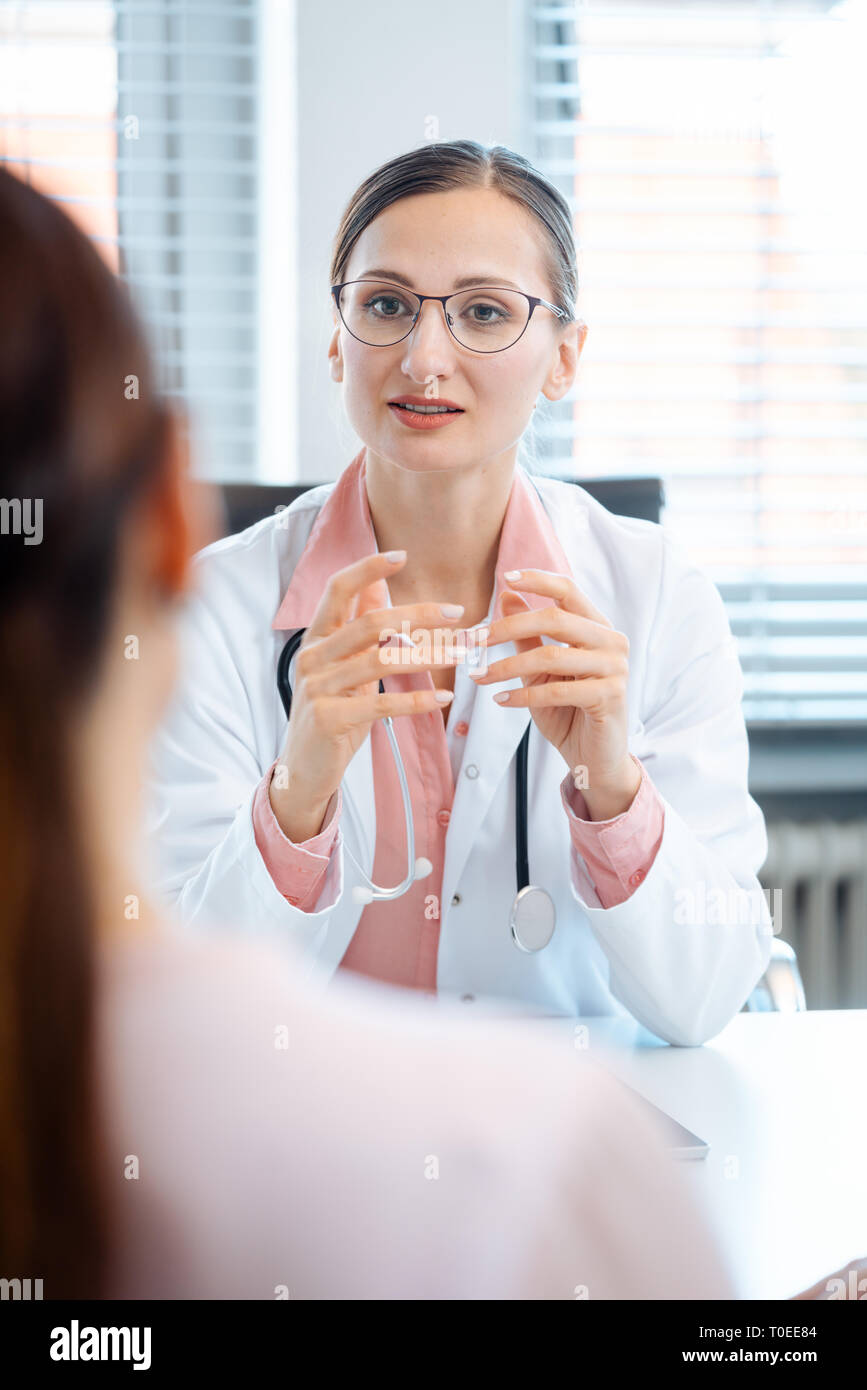 Young female doctor seeing woman patient Stock Photo - Alamy