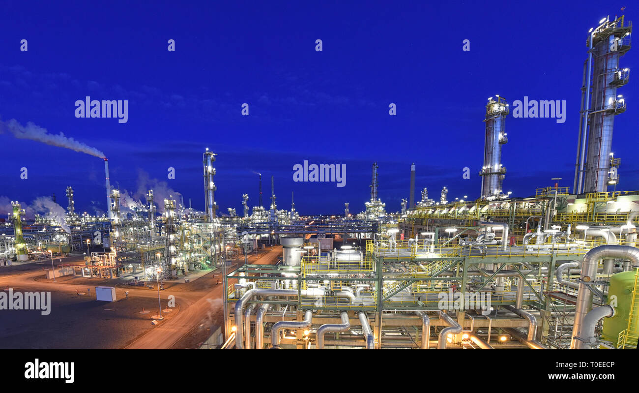 refinery - chemical factory at night with buildings, pipelines and ...