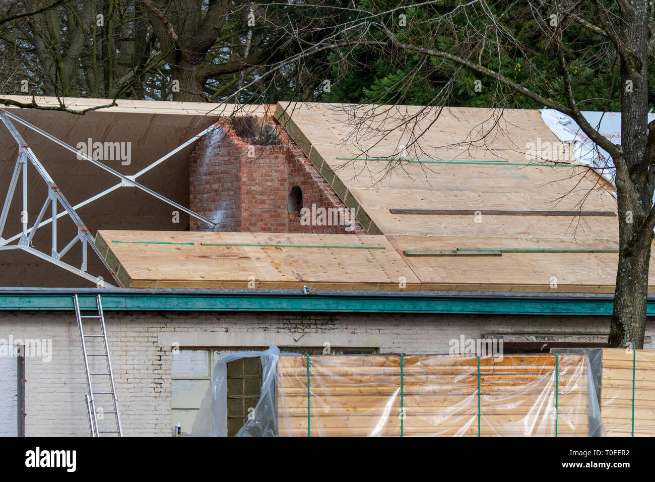 Building fitted with warm pitched roof insulation by installing ...