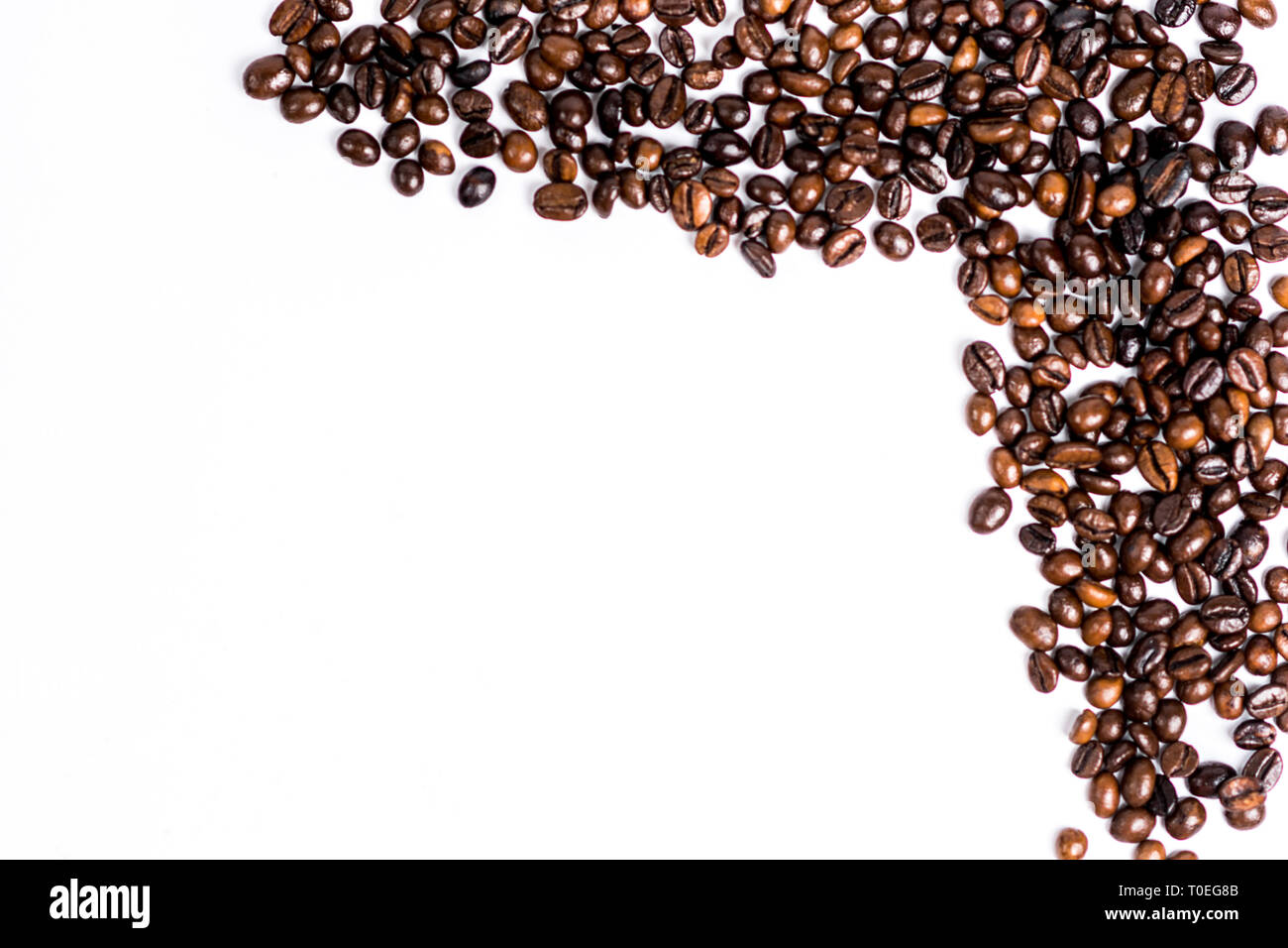 Roasted coffee bean isolated in the corner white background with copy space Stock Photo - Alamy