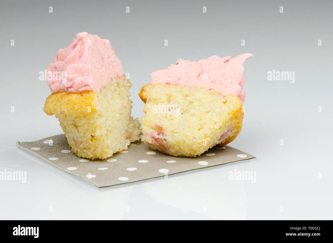 Strawberry cupcake sliced in half. Delicious pink strawberry cupcake ...