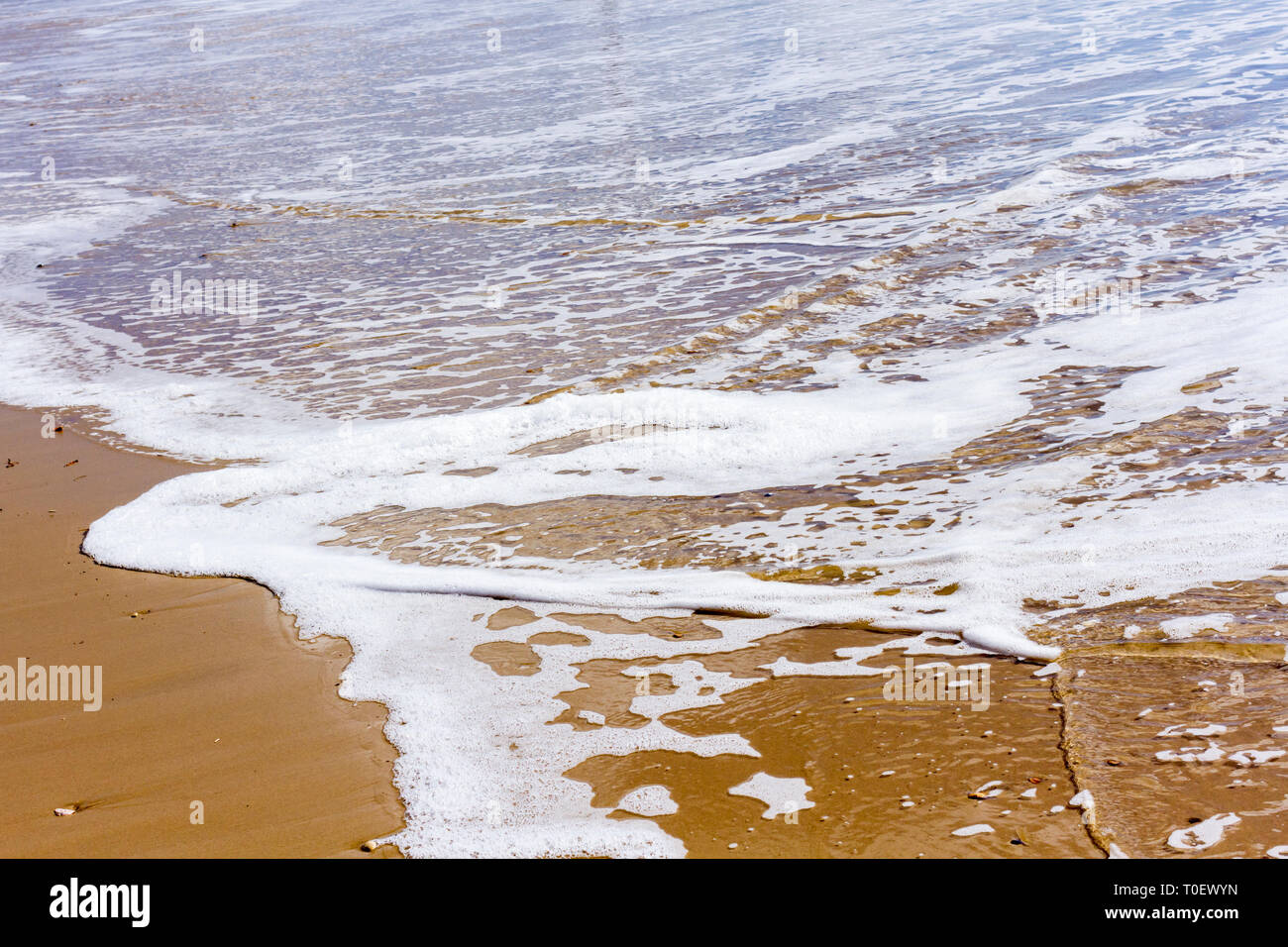 Foamy waves lapping beach hi-res stock photography and images - Alamy