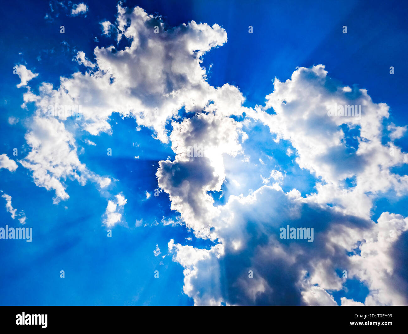 Bottom to top view of dramatic clouds with sun rays coming through ...