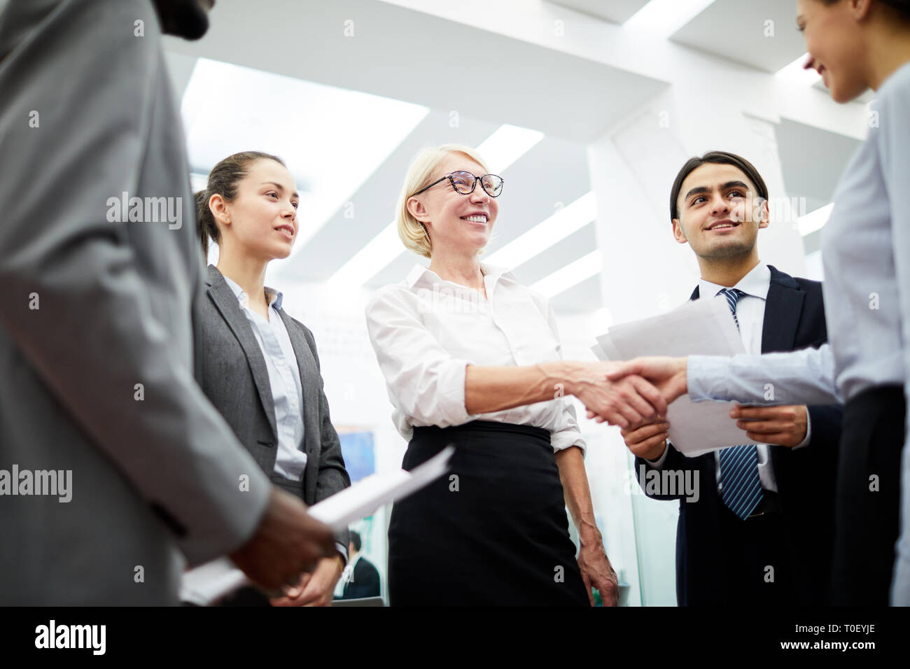 Female Boss Greeting Partner Stock Photo - Alamy