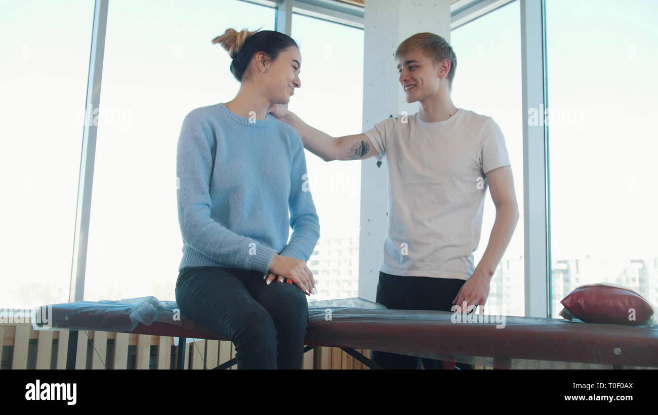Massage session. A young woman receiving a relaxing back massage. View ...