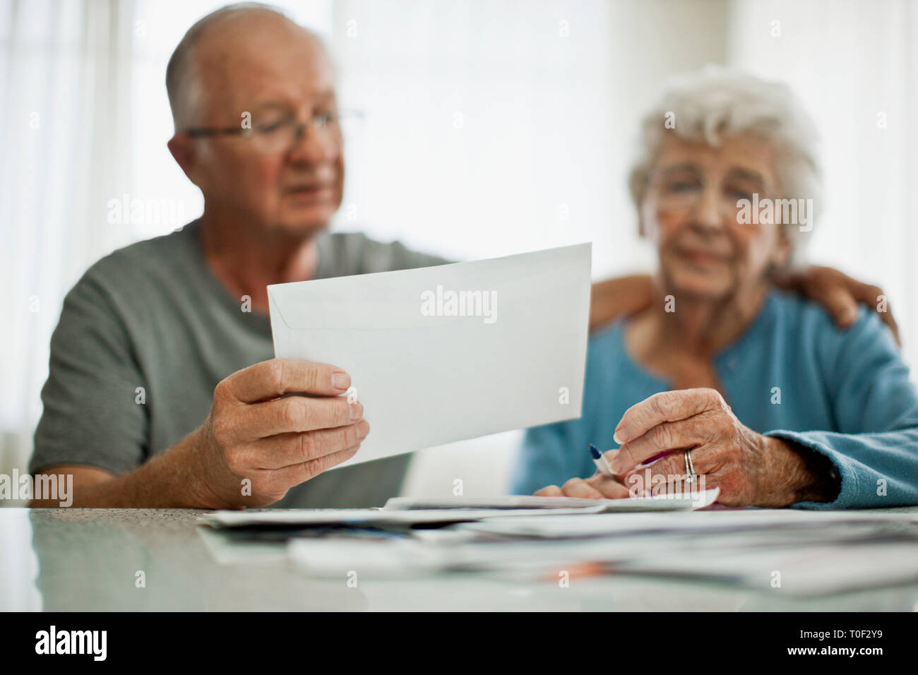 Elderly reading bill hi-res stock photography and images - Alamy
