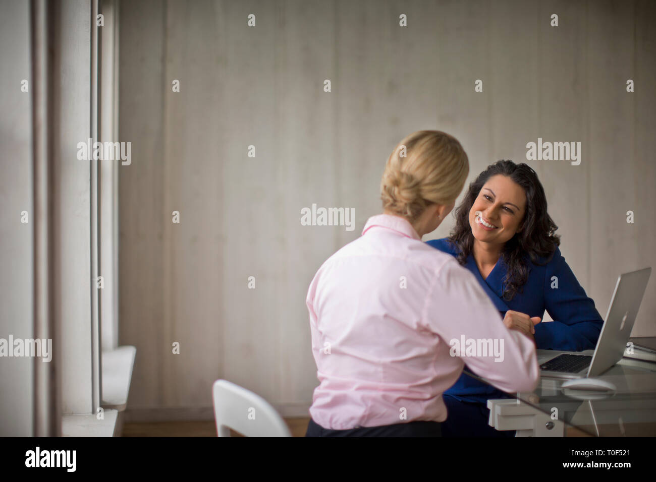 Two colleagues talking at work Stock Photo - Alamy
