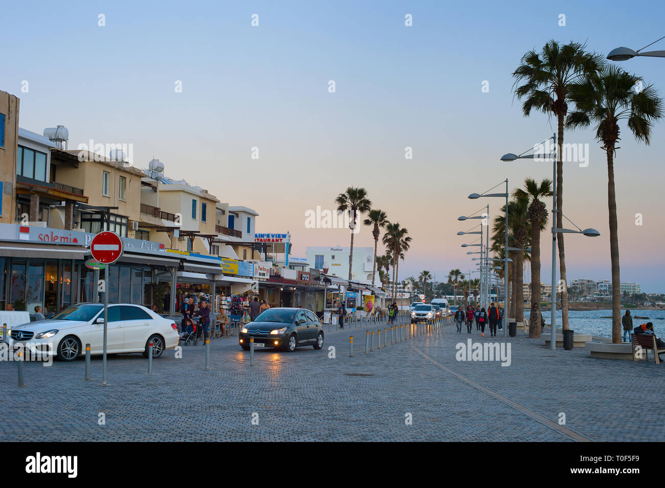 PAPHOS, CYRPUS - FEBRUARY 13, 2019: People walking by Cyprus promenade ...