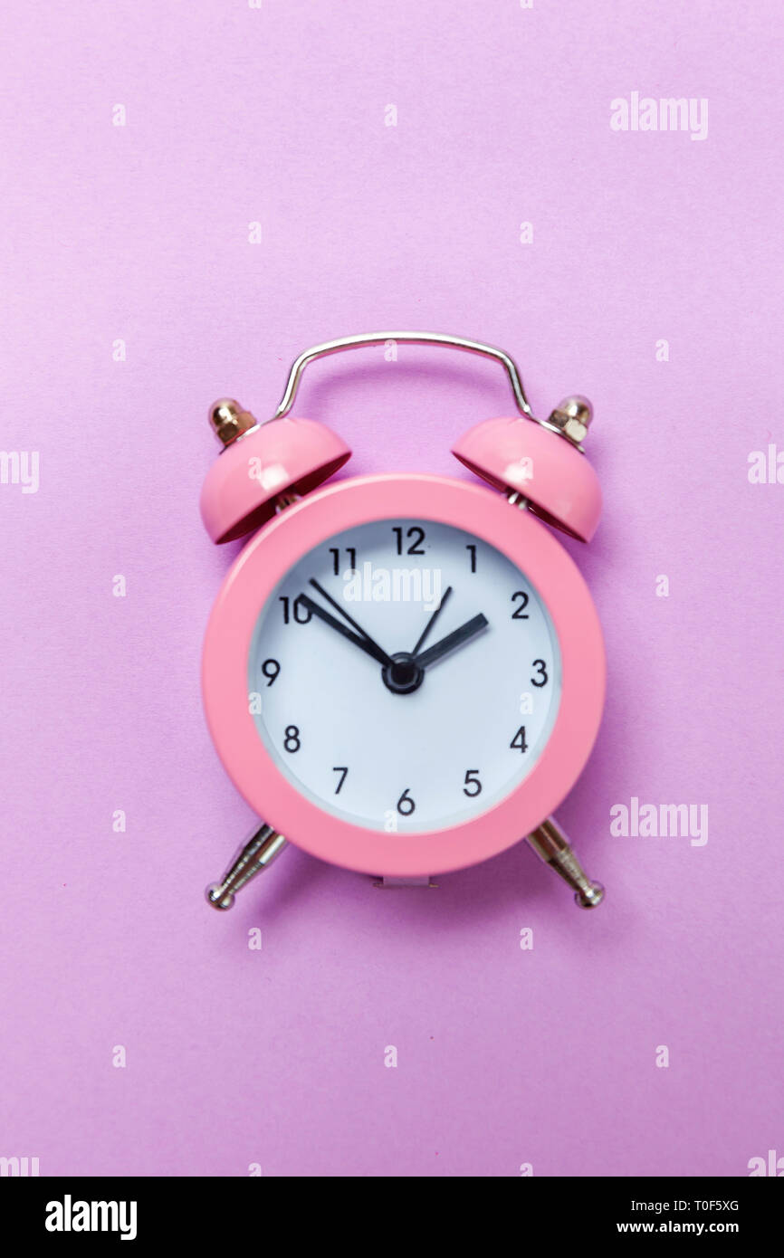 Ringing twin bell vintage classic alarm clock Isolated on purple violet ...