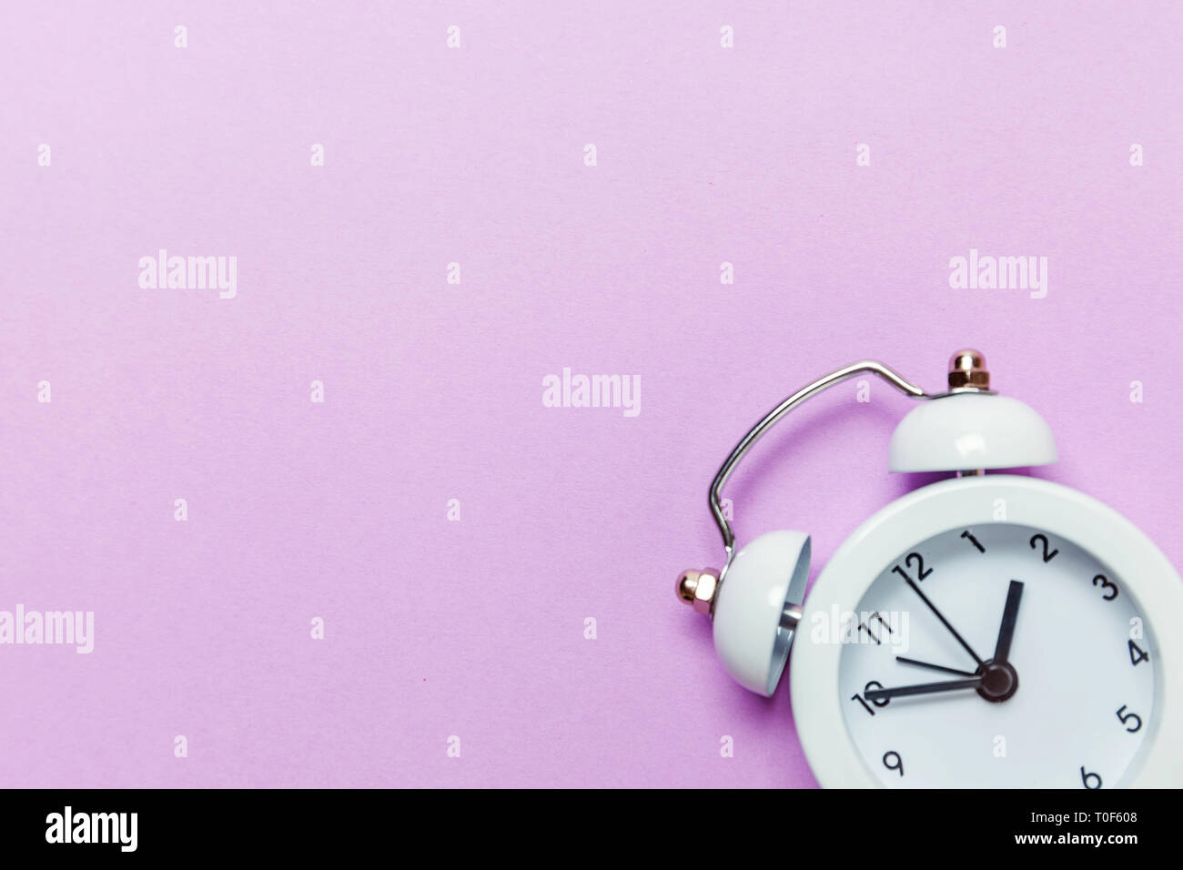 Ringing twin bell vintage classic alarm clock Isolated on purple violet ...