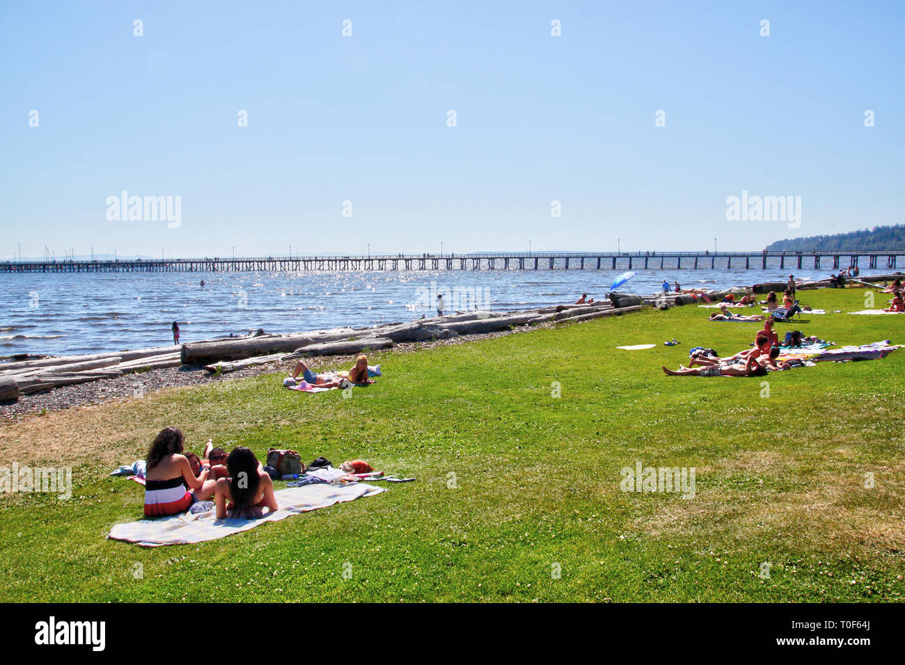 WHITE ROCK Canada - JUL 23, 2010: Visitors resting along popular White ...