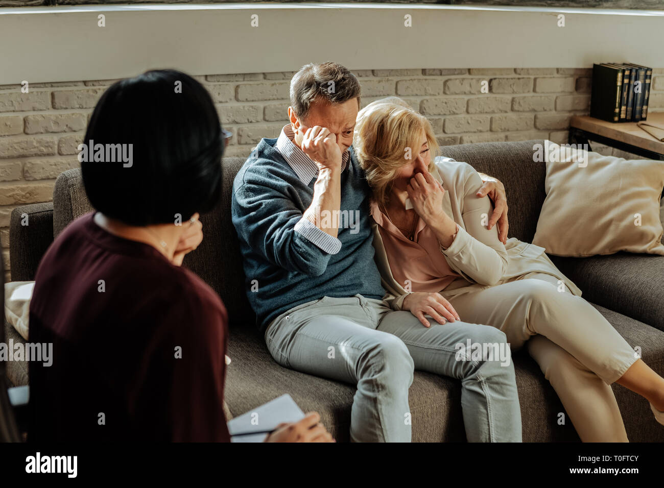 Couple woman crying on couch hi-res stock photography and images - Alamy