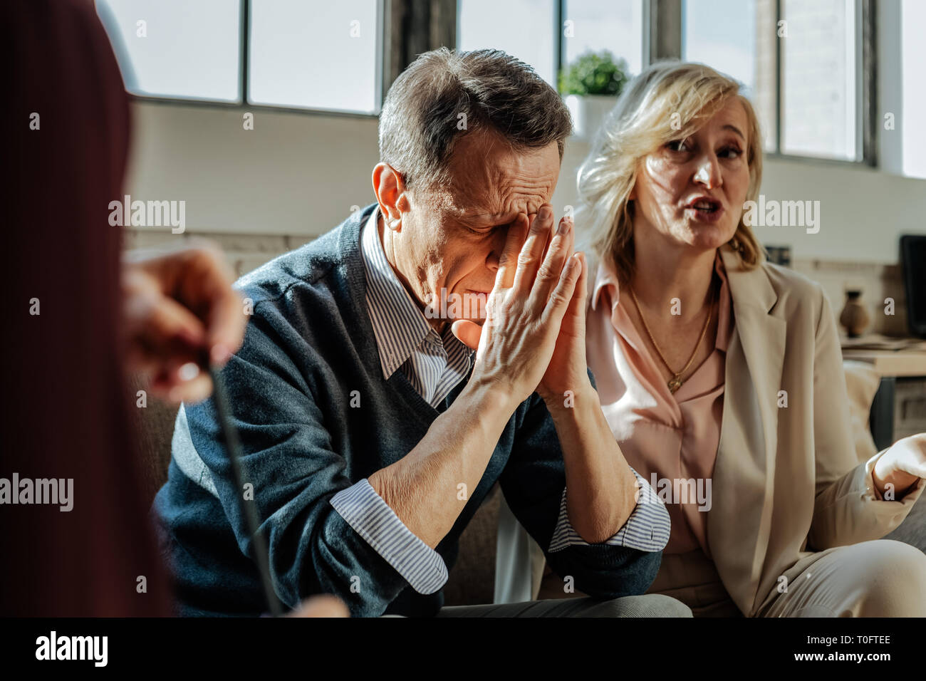 Distressed old man being depressed with situation in his family Stock ...