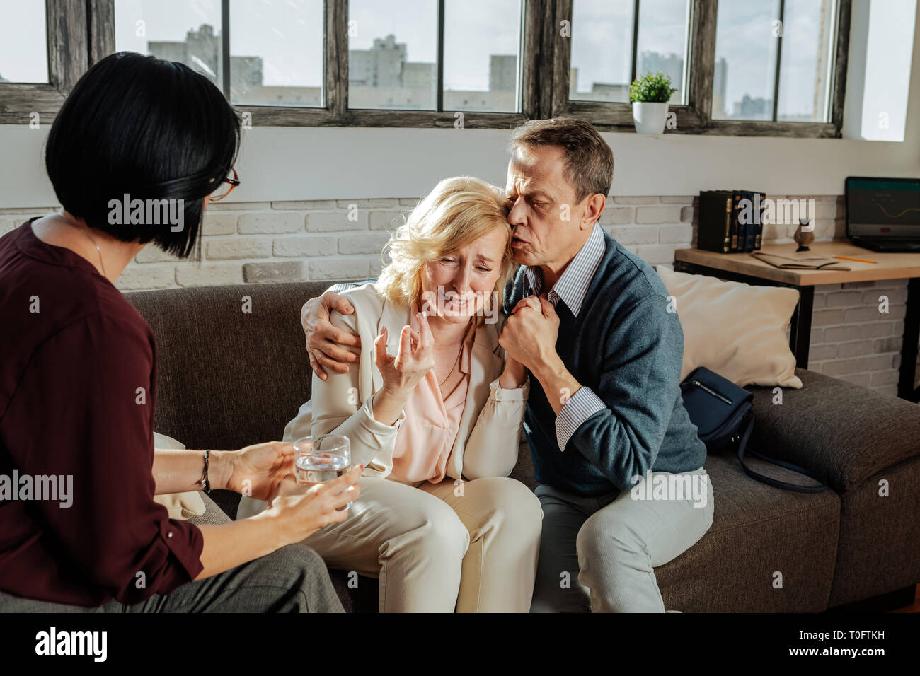 Distressed blonde woman being desperate about the situation with her ...