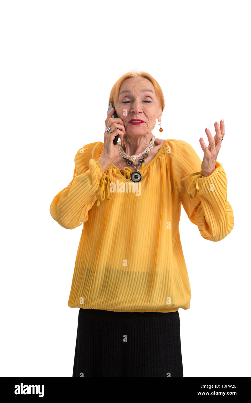 Elderly woman with cell phone. Senior lady on white background. Listen ...