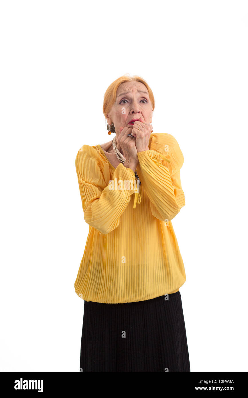 Worried old lady. Nervous woman on white background. The great danger ...