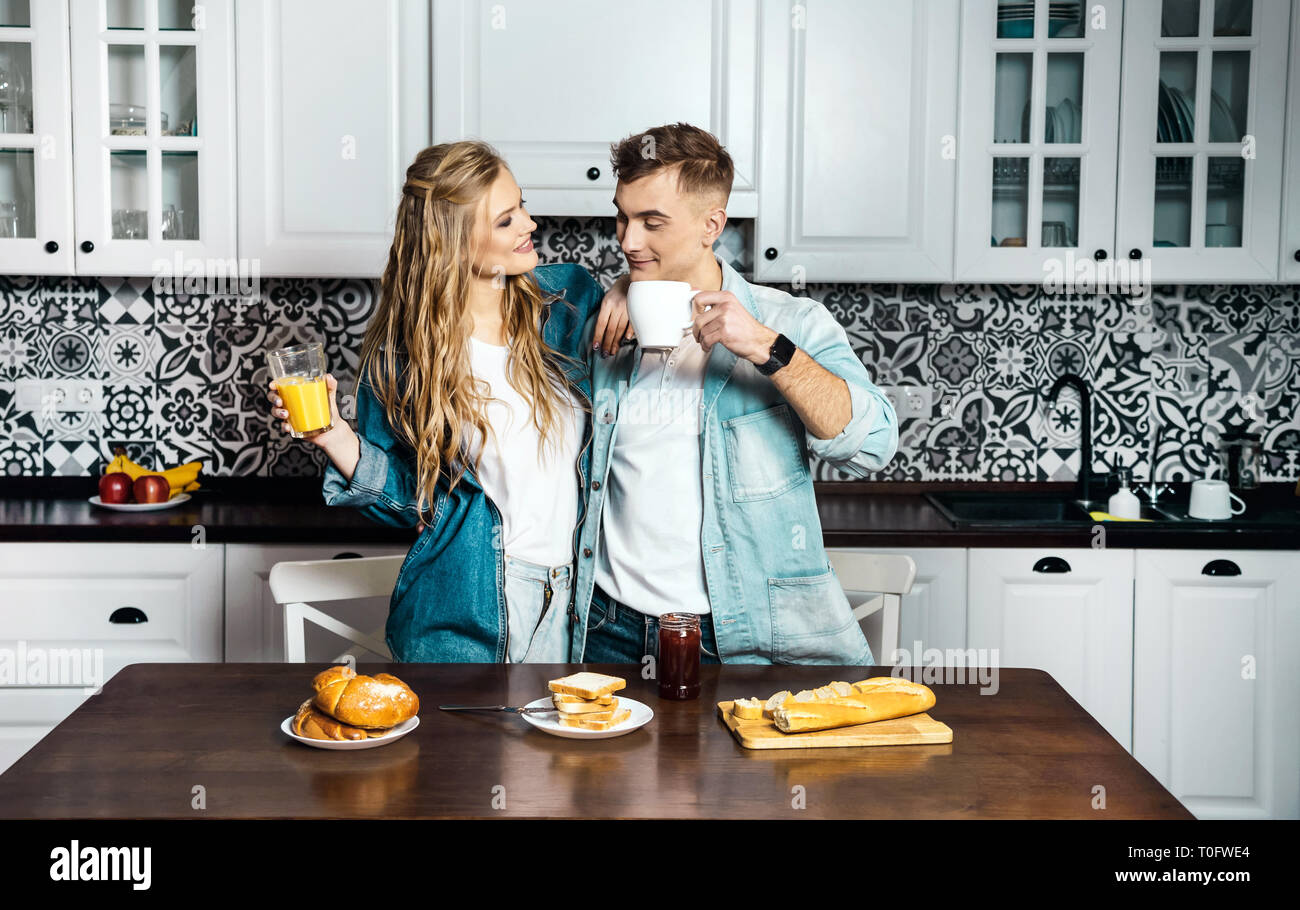 Romantic couple having breakfast at the light kitchen Stock Photo - Alamy
