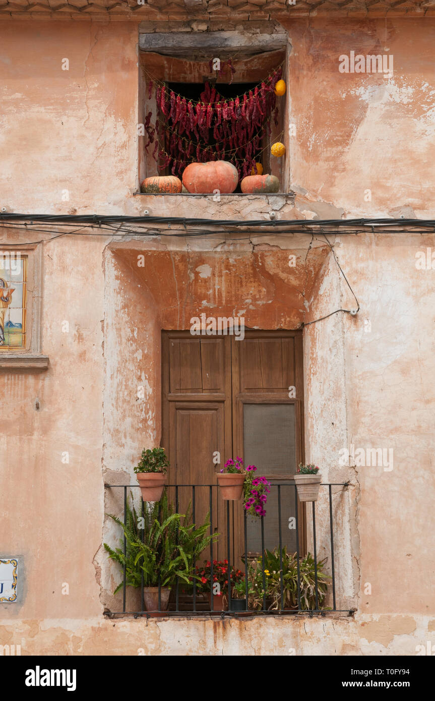 Red chilli peppers and other fruit drying outside a house in Bocairent ...
