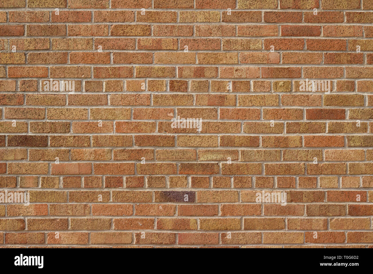 Weathered brown brick wall background in varying shades of salmon pink ...