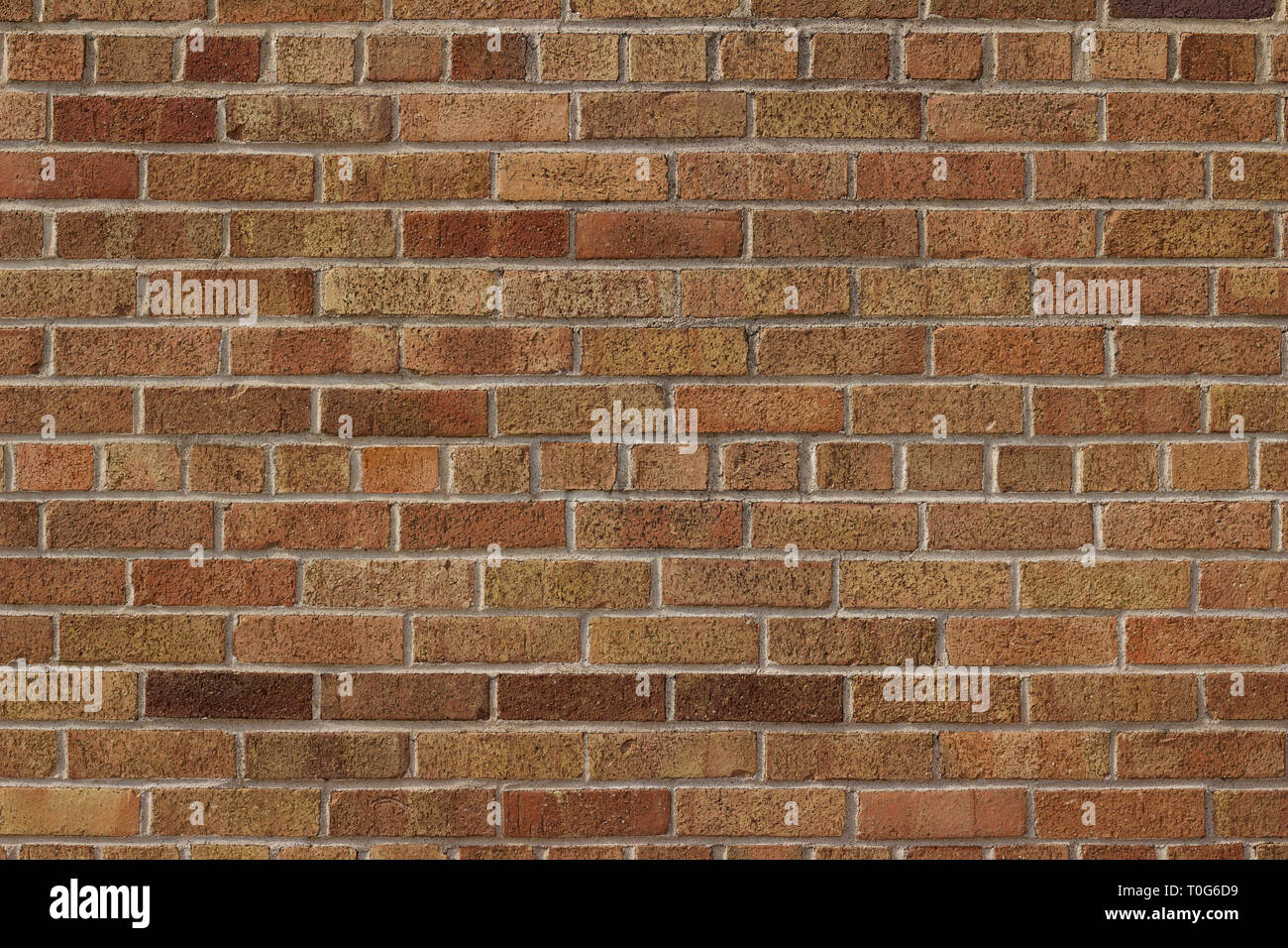 Weathered brown brick wall background in varying shades of salmon pink ...