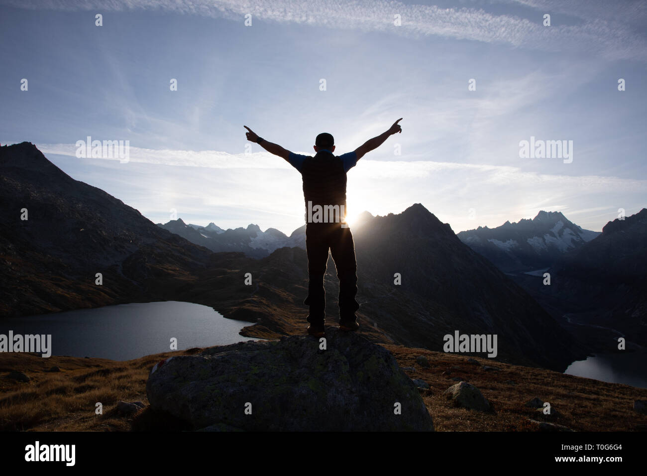 Happy man silhouette with arms raised in success on sunrise hi-res ...
