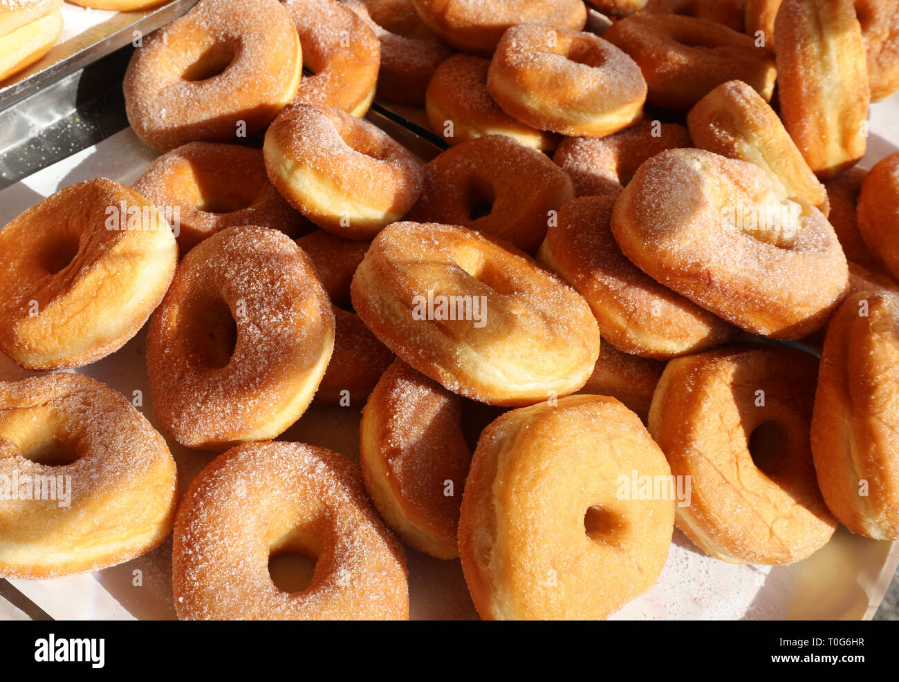 fried doughnut with sugar for sale at stand on the street Stock Photo ...