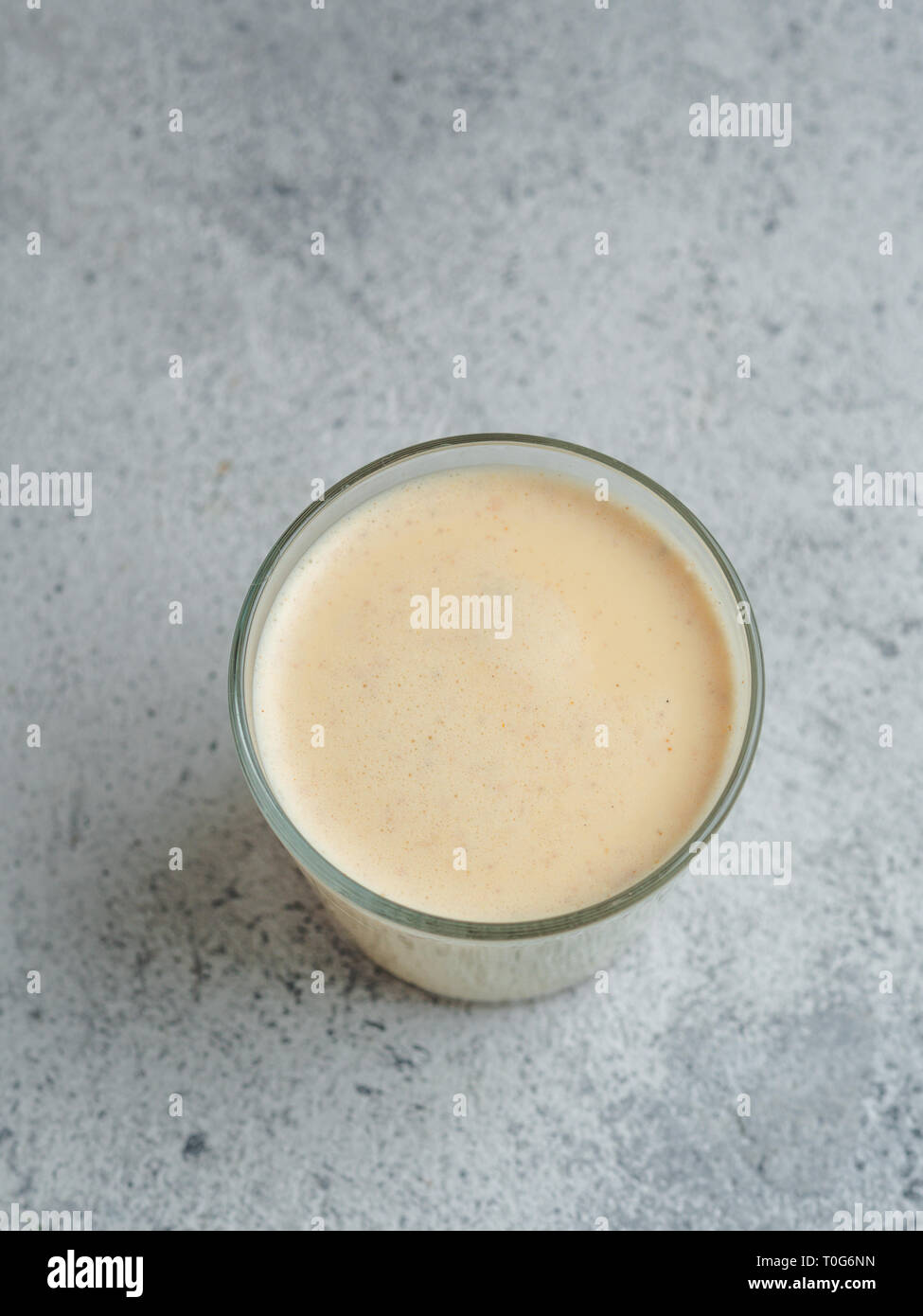 Healthy drink golden turmeric latte in glass cup. Yellow homemade latte ...