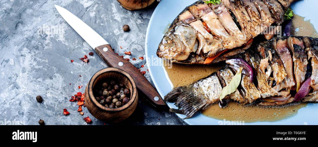 Grilled whole fish with citrus, and vegetable on rustic table Stock ...