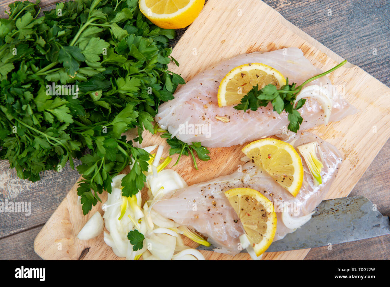 Fresh fish, a raw cod fillets with addition of herbs and lemon Stock ...