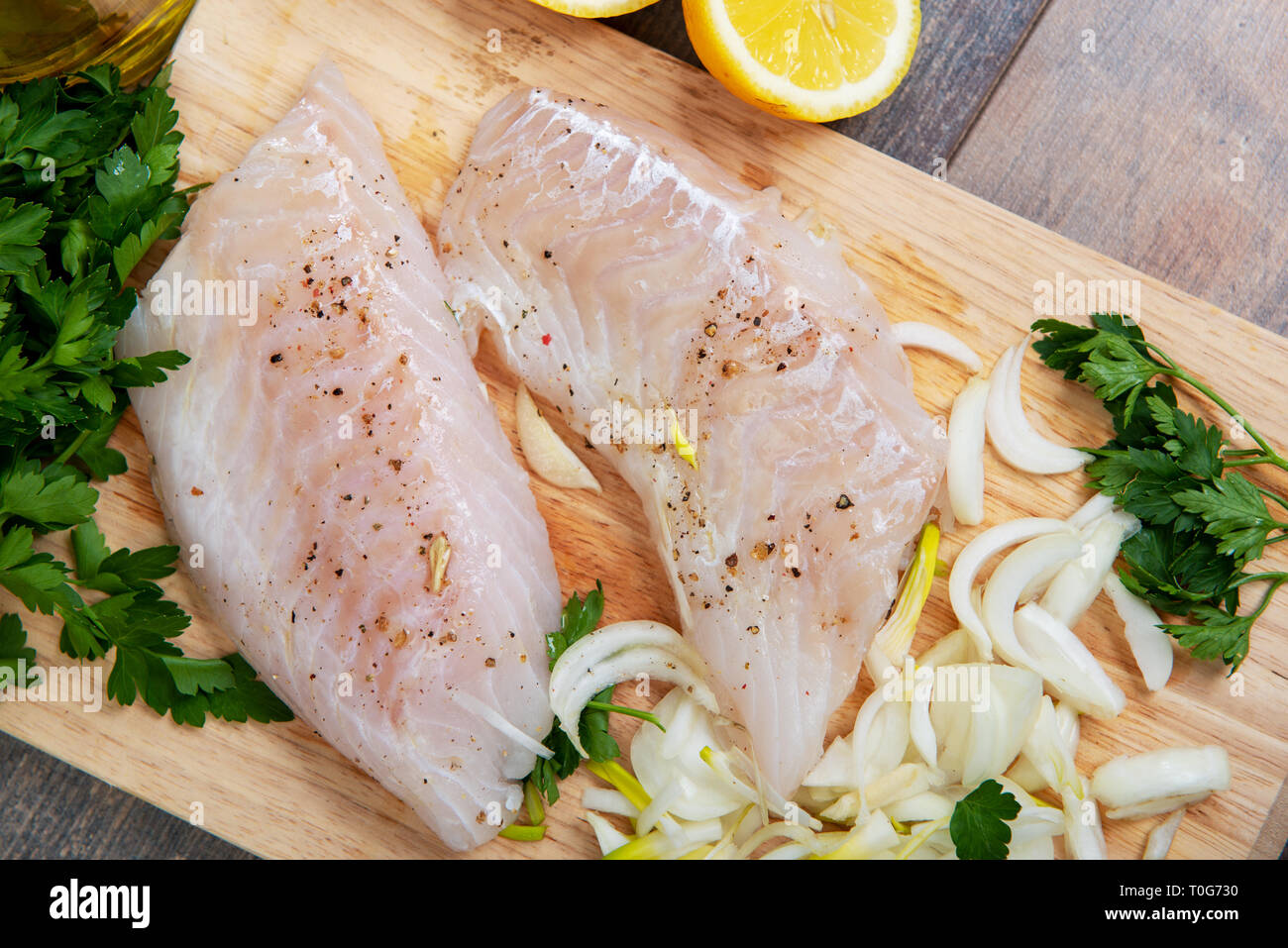 Fresh fish, a raw cod fillets with addition of herbs and lemon Stock ...