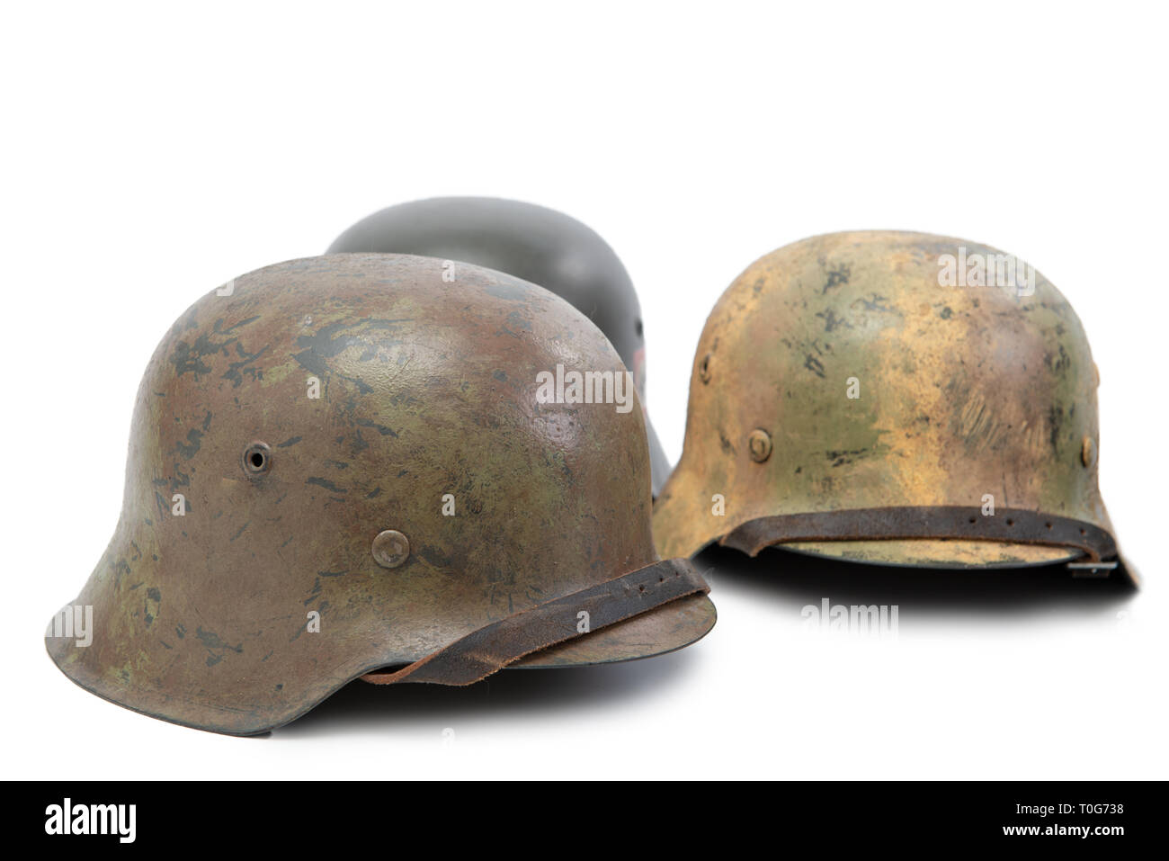 three German World War Two (Stahlhelm) military helmets isolated on ...