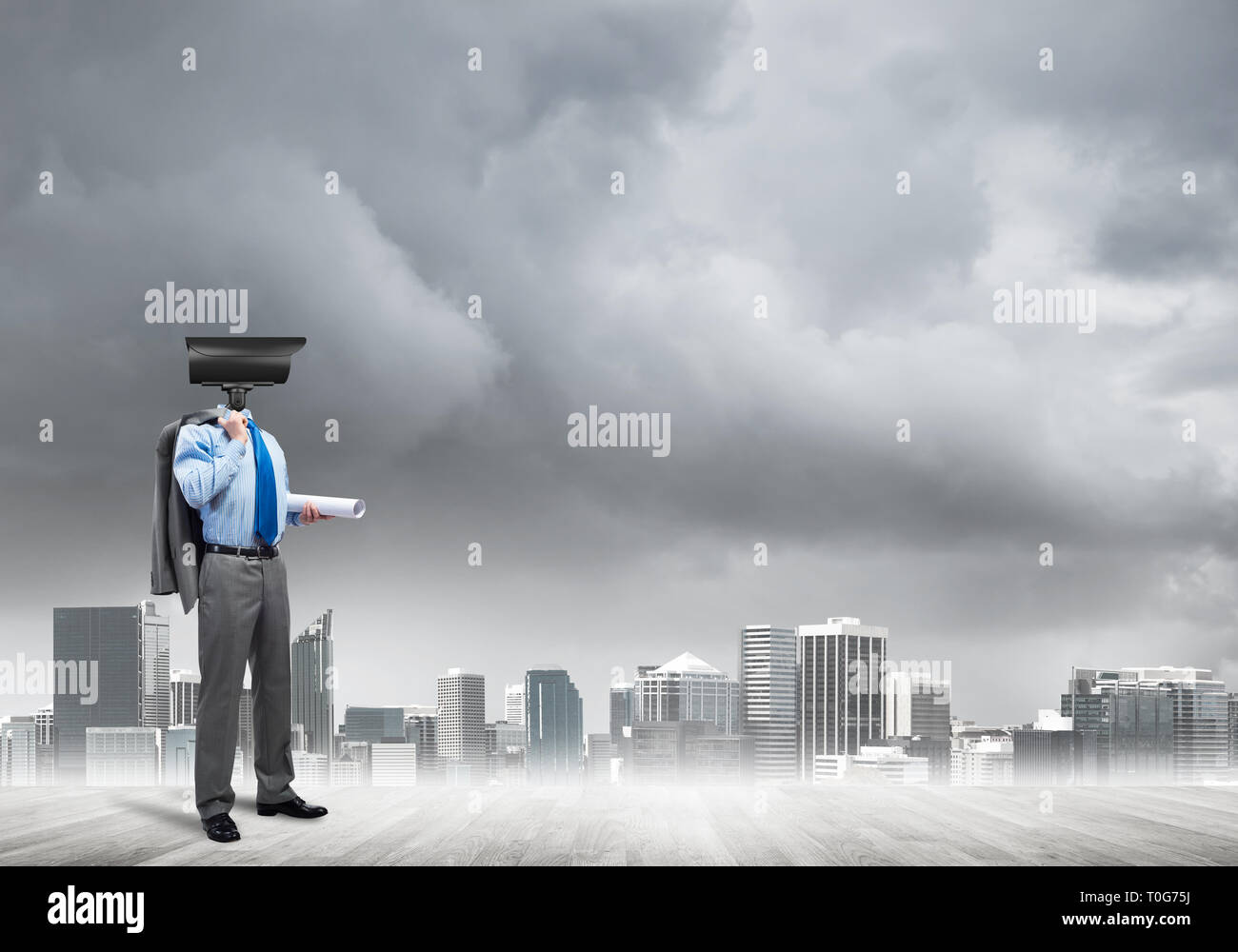 Camera headed man standing on wooden floor against modern cityscape ...