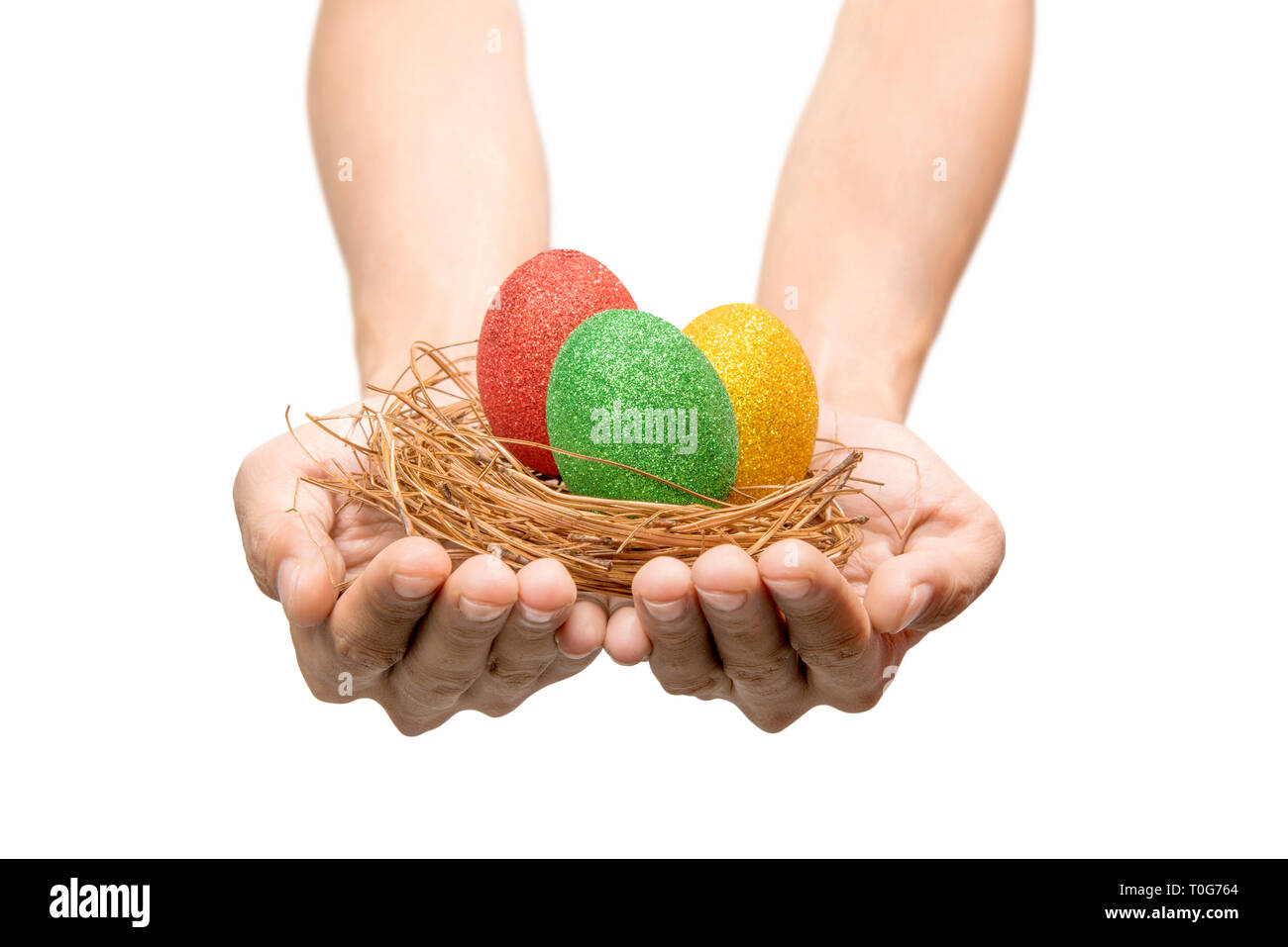 Human hands holding nest with colorful easter eggs isolated over white ...