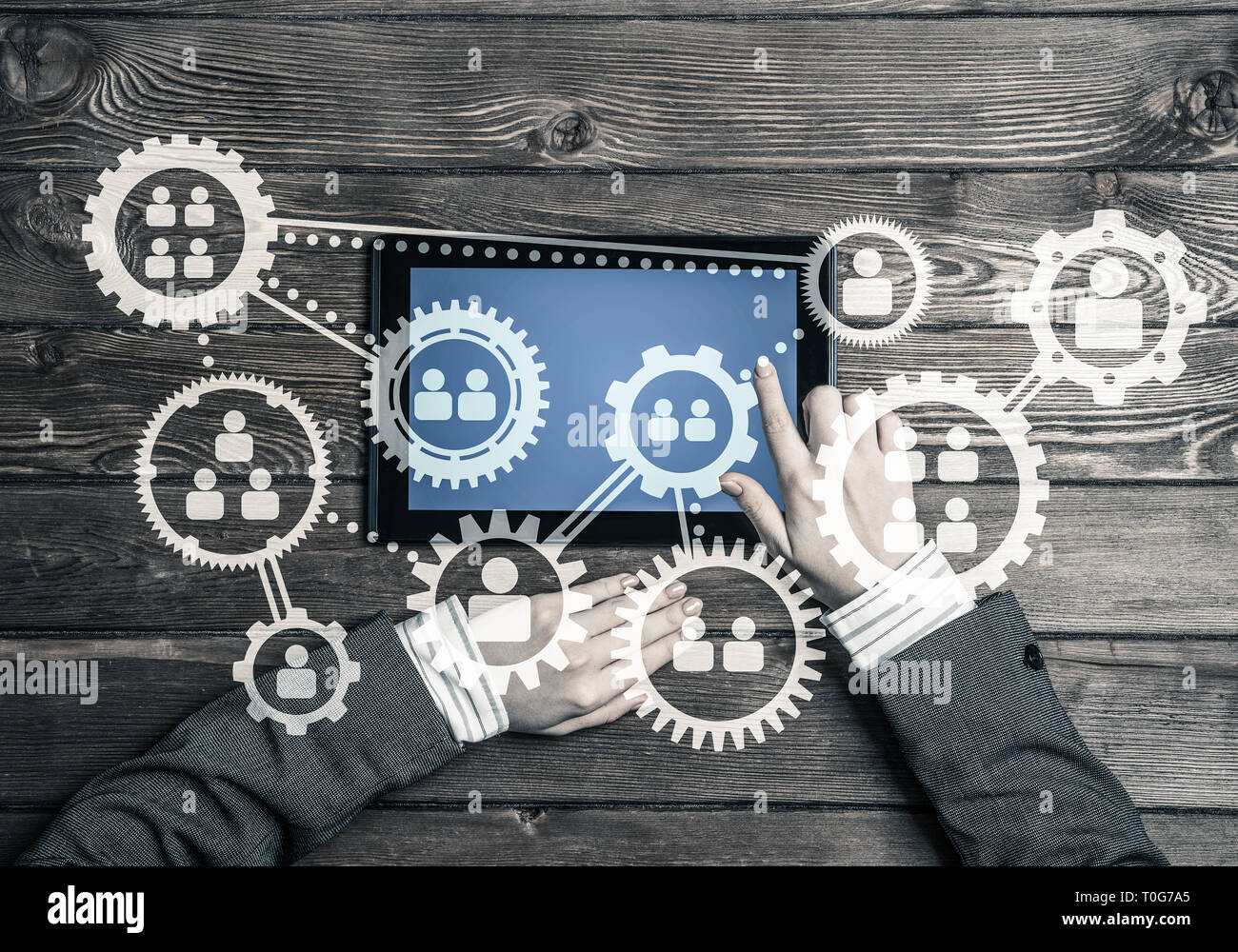 Concept of teamworking and connection with gears mechanism and tablet ...