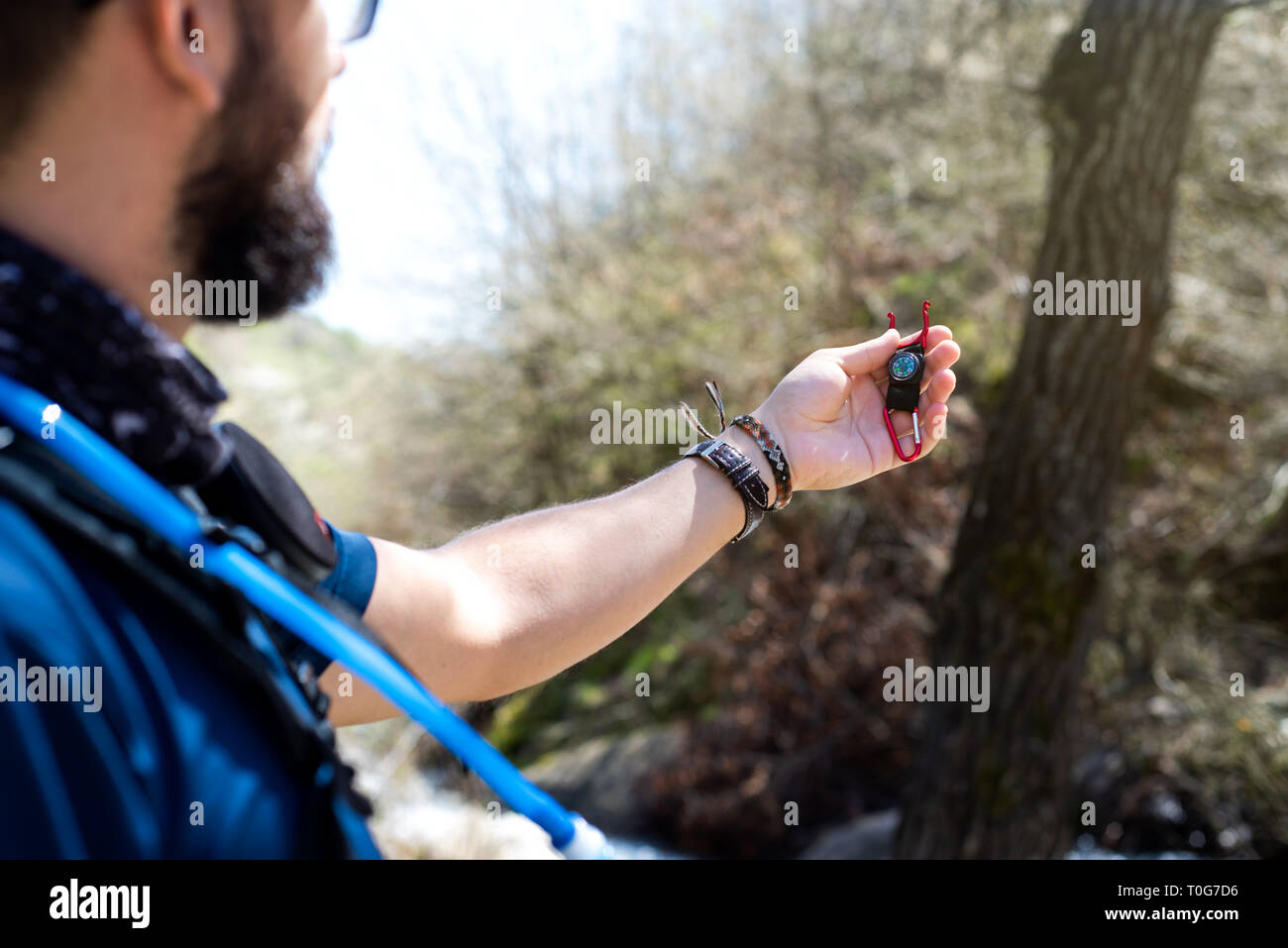 Man holding a small compass close up Stock Photo - Alamy