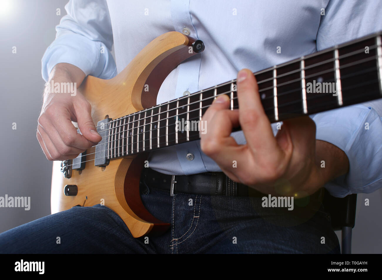 Male arms playing classic shape electric guitar Stock Photo - Alamy