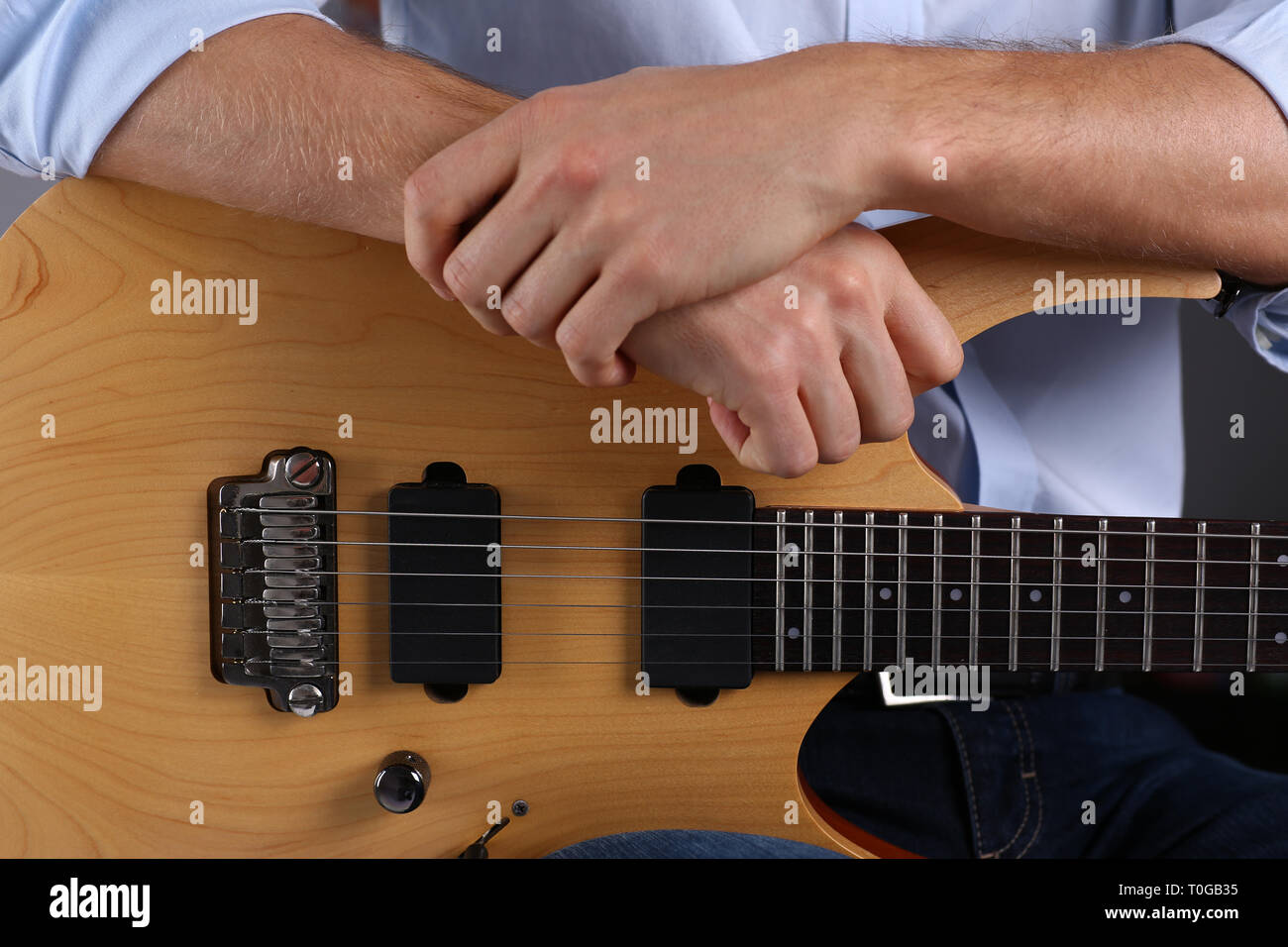 Male arms playing classic shape electric guitar Stock Photo - Alamy