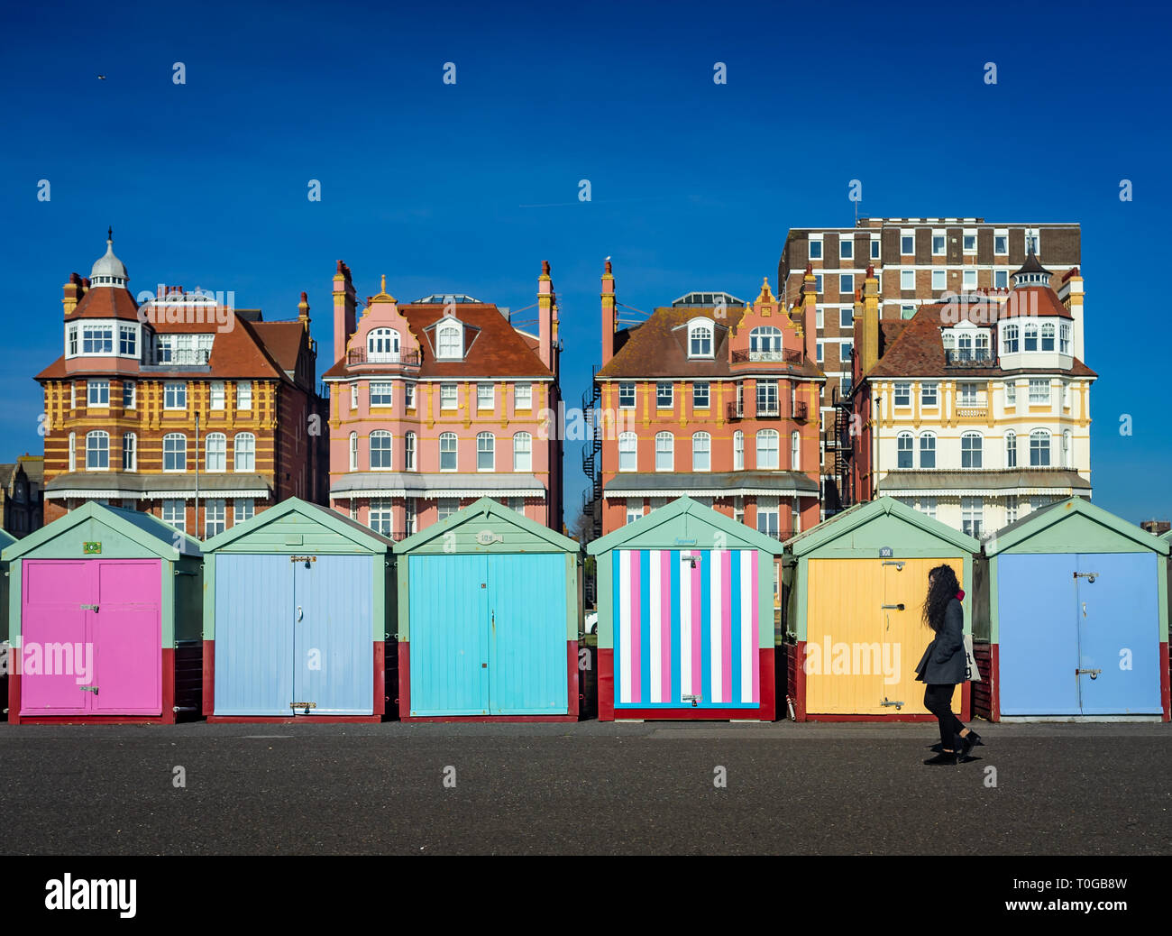 Strolling past beach huts hi-res stock photography and images - Alamy