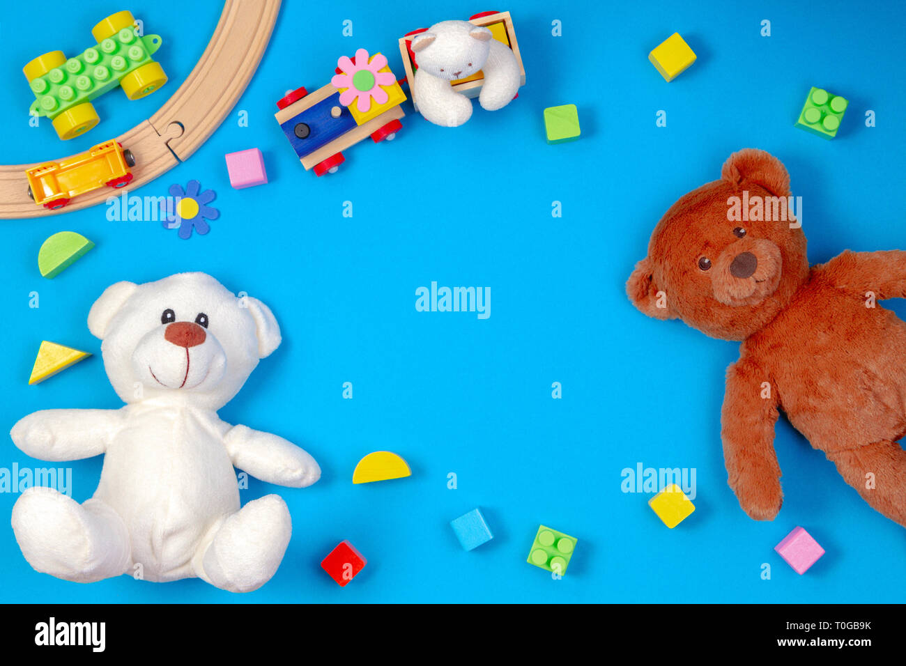Kids toys background with teddy bear, wooden train and colorful blocks ...