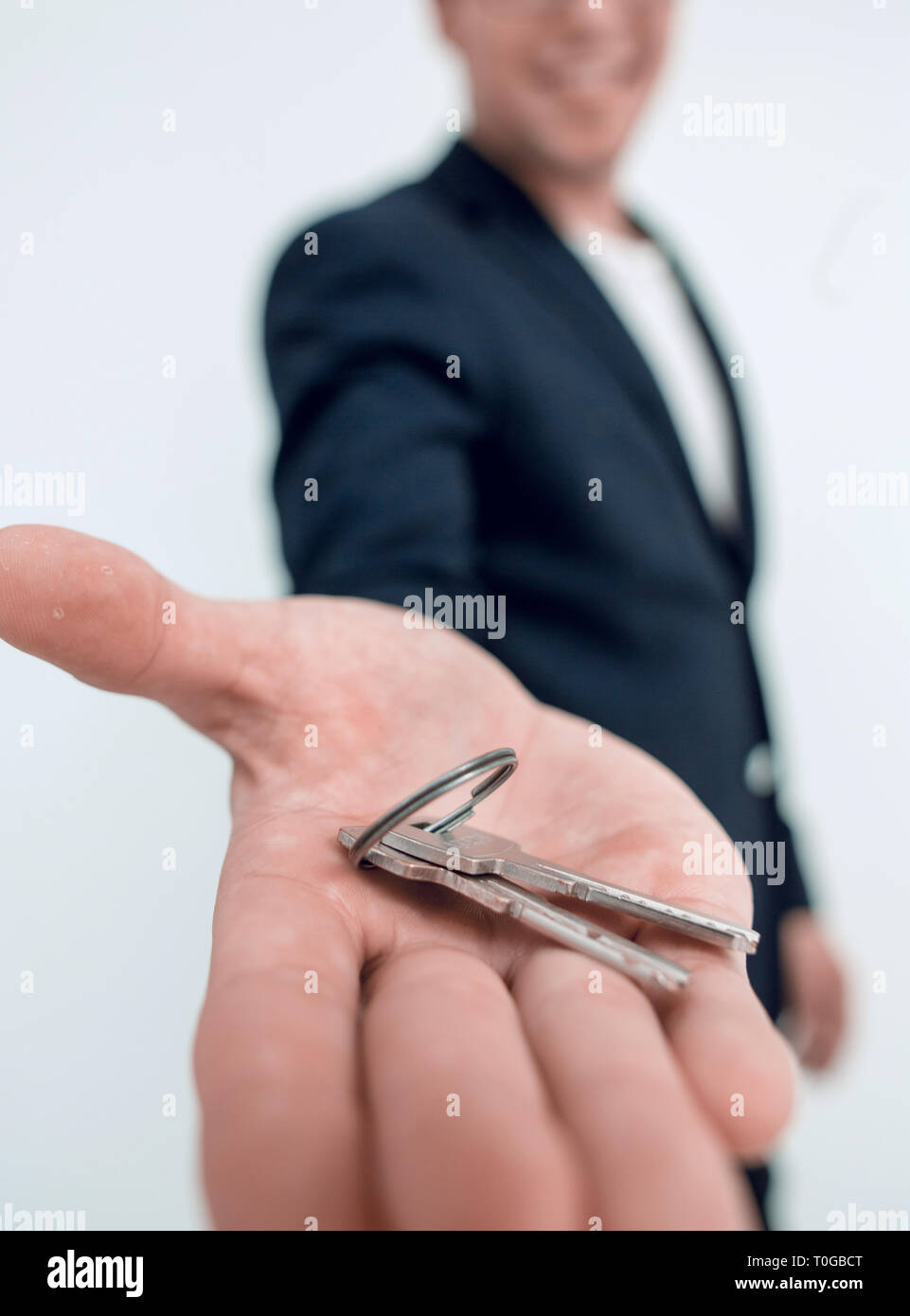 Man holding out keys hi-res stock photography and images - Alamy