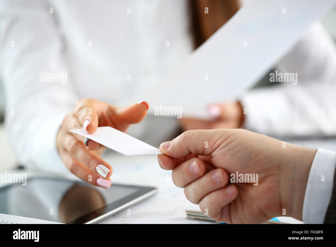 Female arm in suit give blank calling card to visitor Stock Photo - Alamy